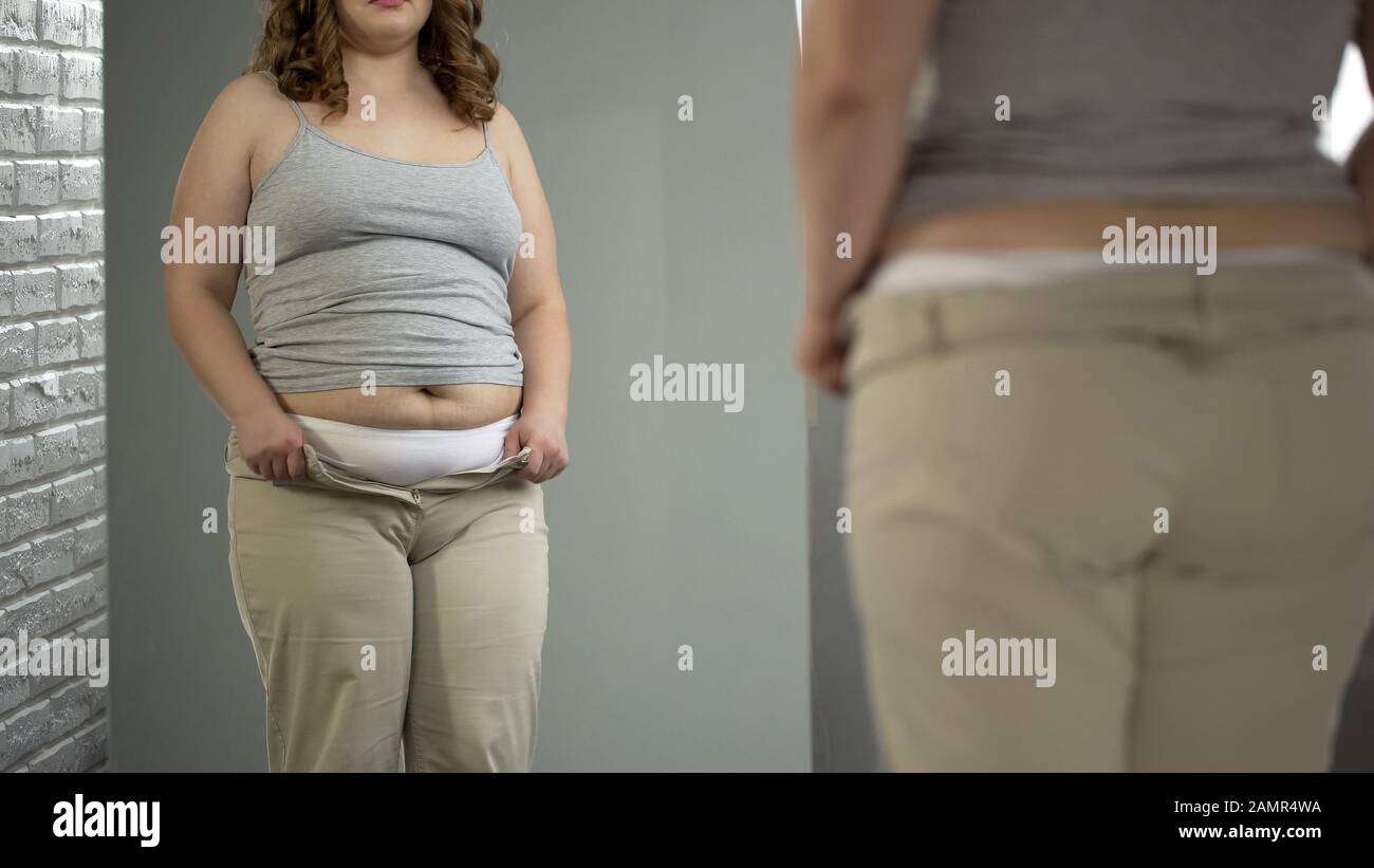 Curvy lady cannot get into her pants, overeating result, obesity ...