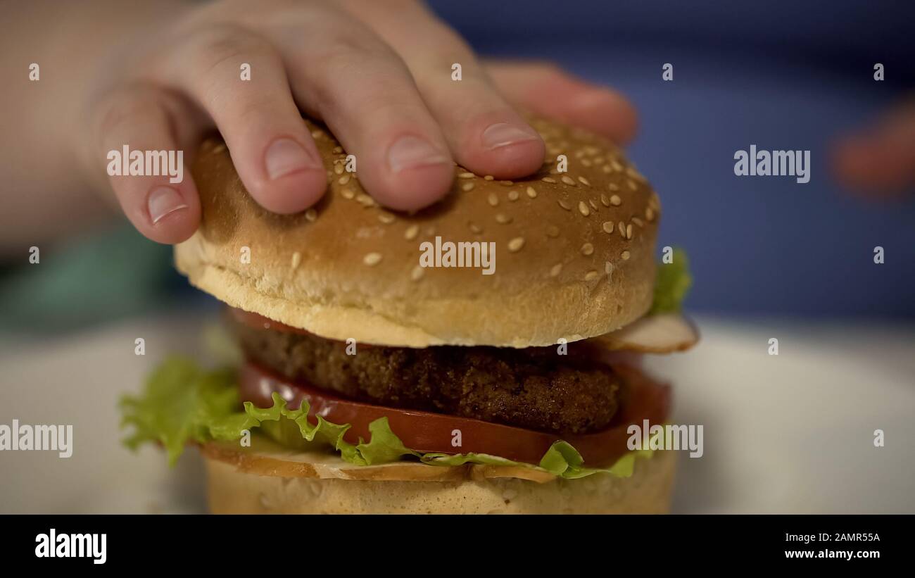 Female preparing to eat unhealthy fatty burger, obesity and overeating ...