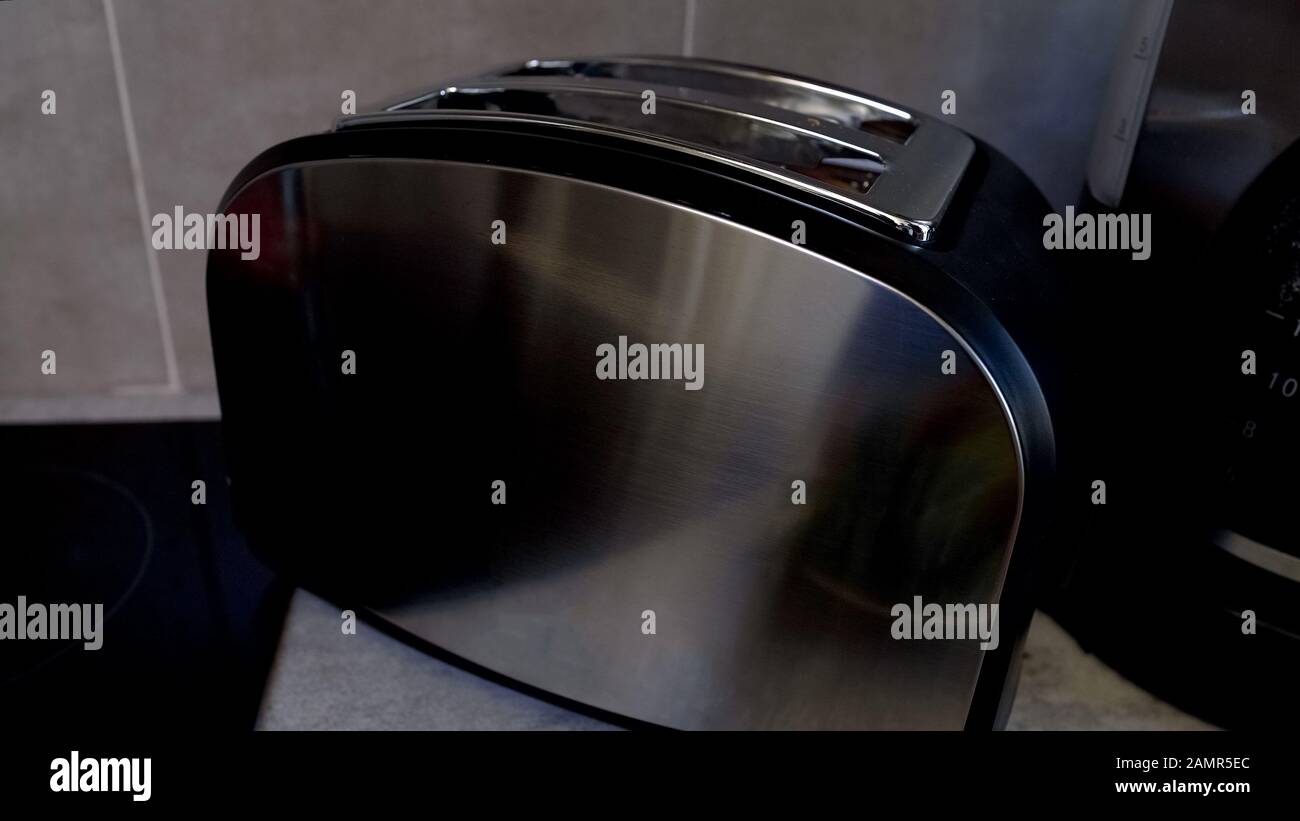 Steel toaster in kitchen, modern electrical home appliances and fire ...