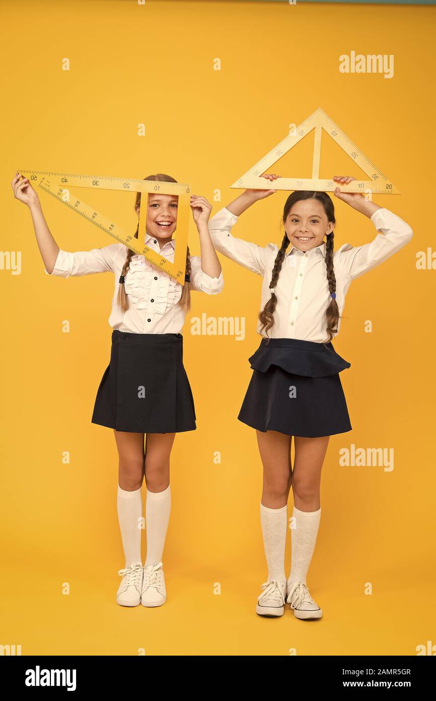 bright minds. Kids in uniform at yellow wall. friendship and sisterhood ...