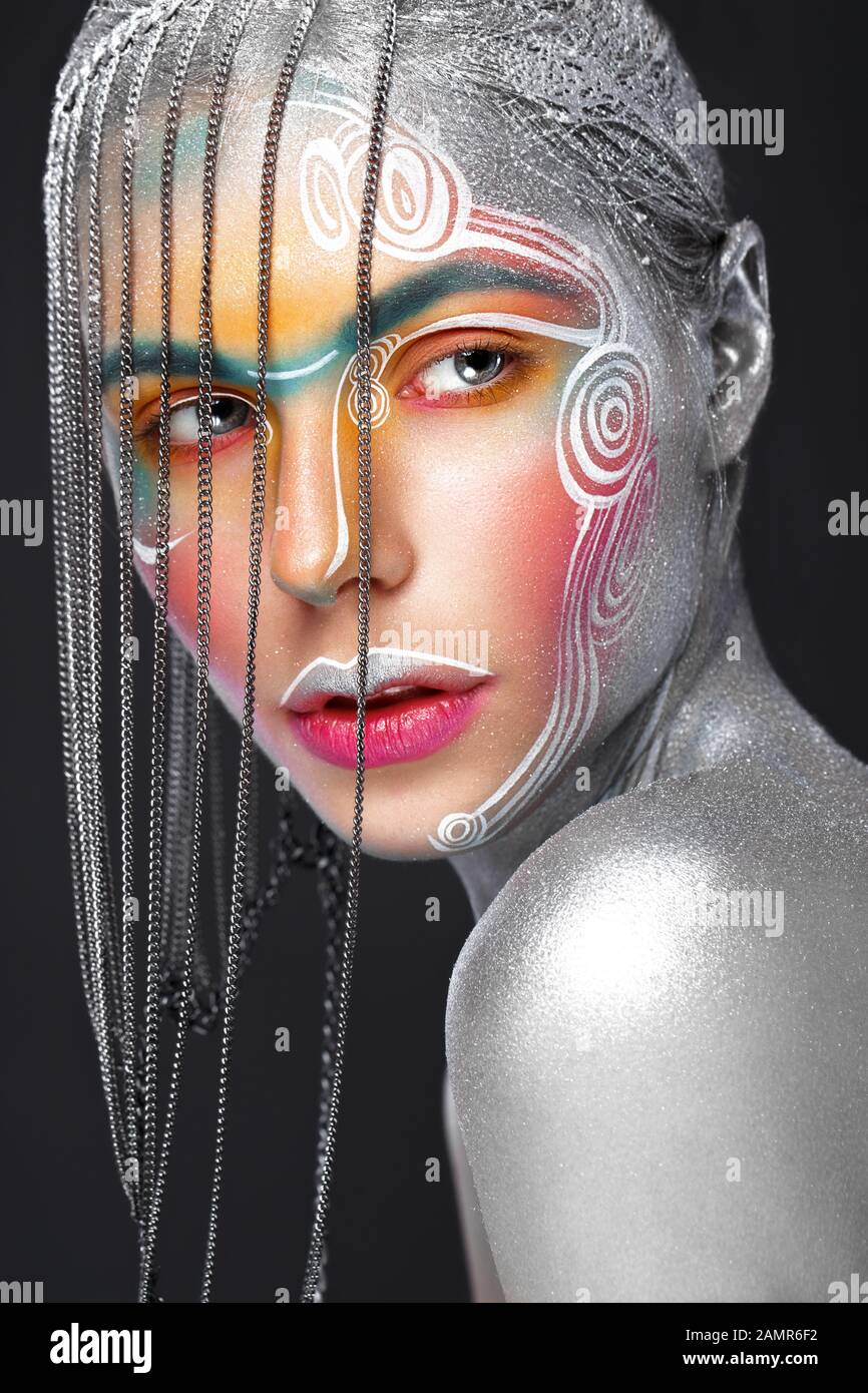 Beautiful girl in an unusual winter look with colorful face. Creative ...