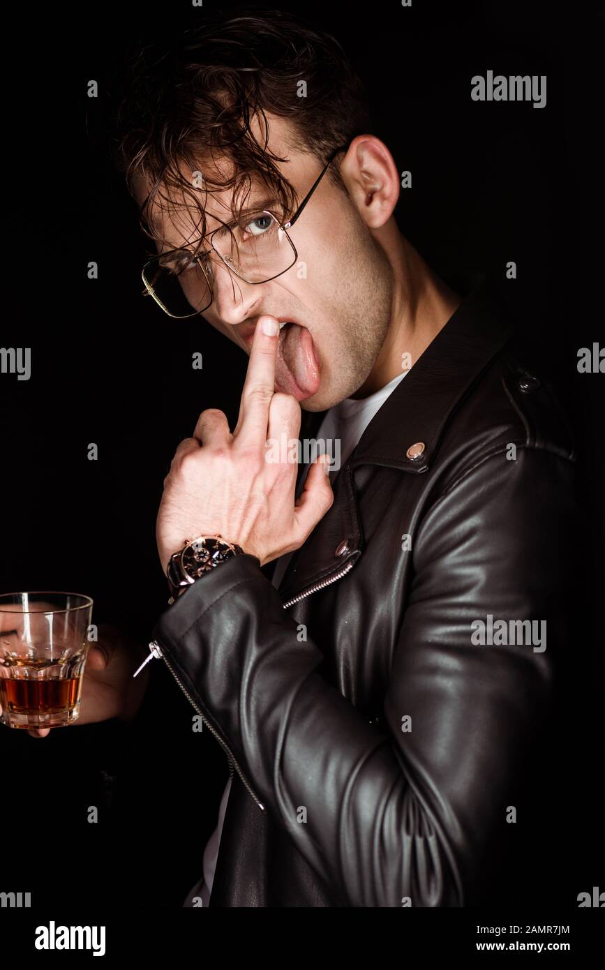 brutal man showing middle finger while sticking out tongue and holding ...
