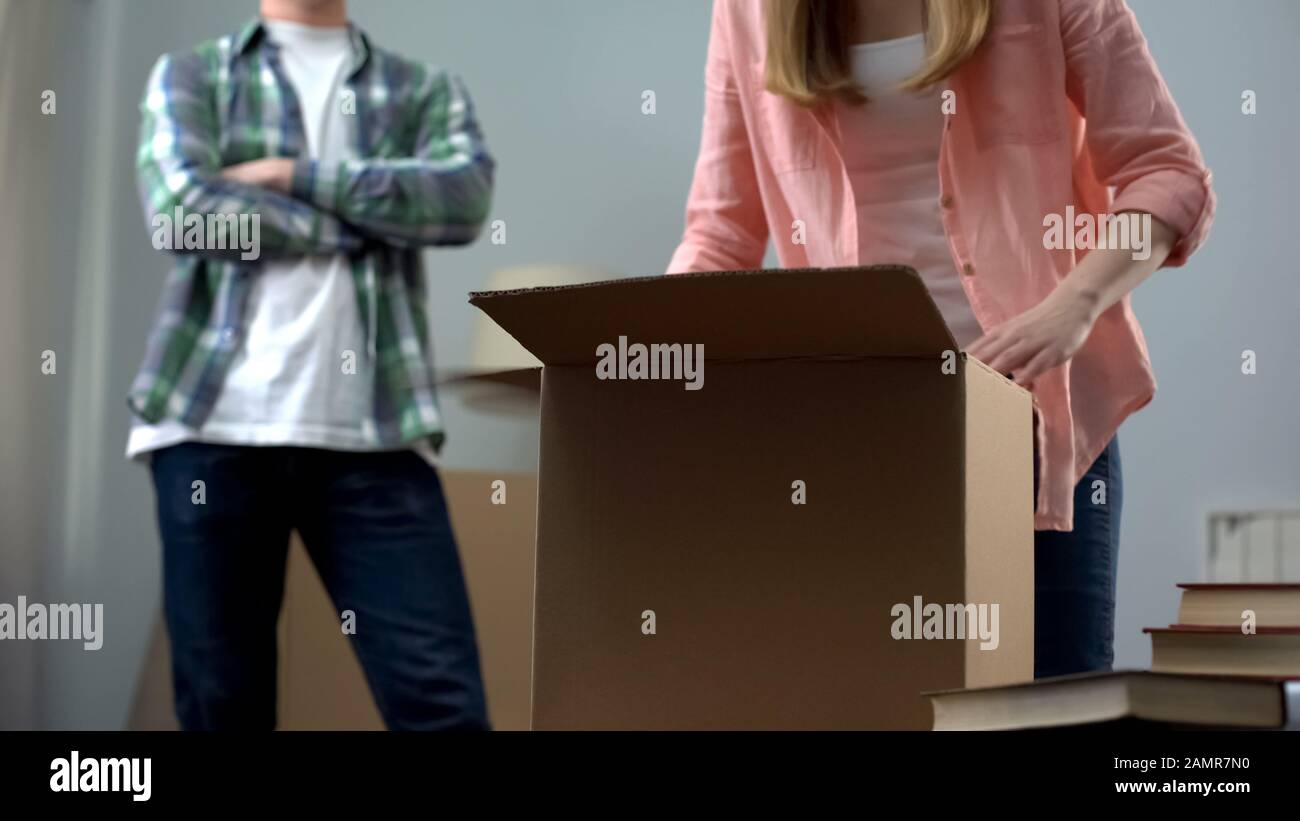 Sad woman packing boxes hi-res stock photography and images - Alamy