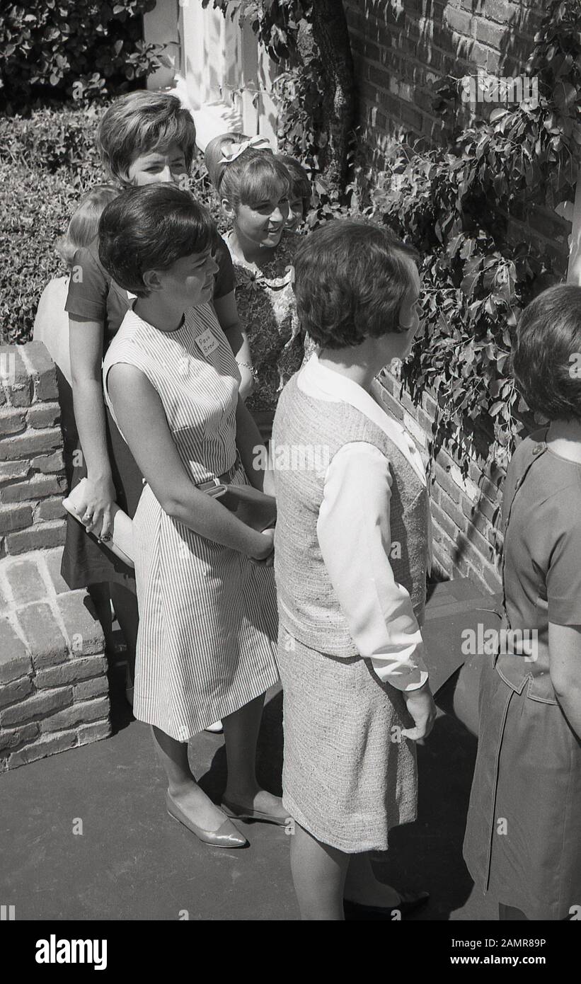 1964, historical, new female students standing queuing up outside at ...