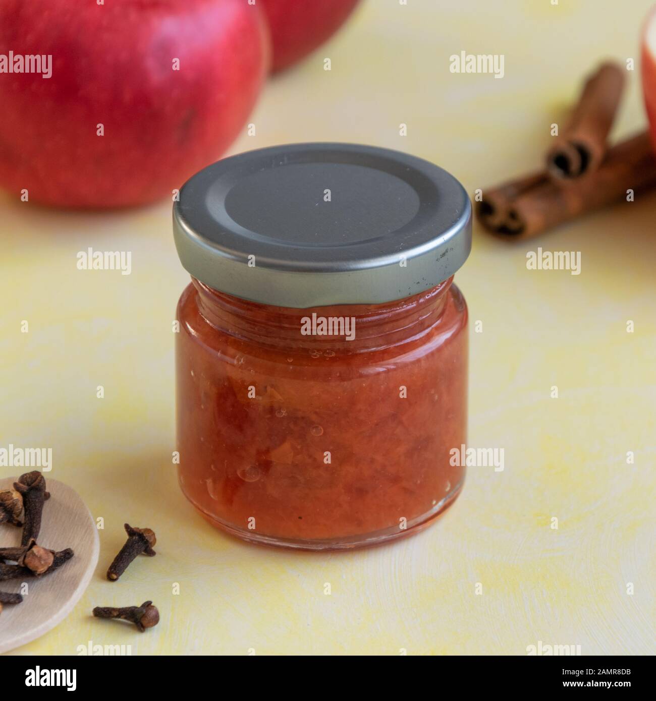 Homemade jam with red apples, cloves and cinamon Stock Photo - Alamy
