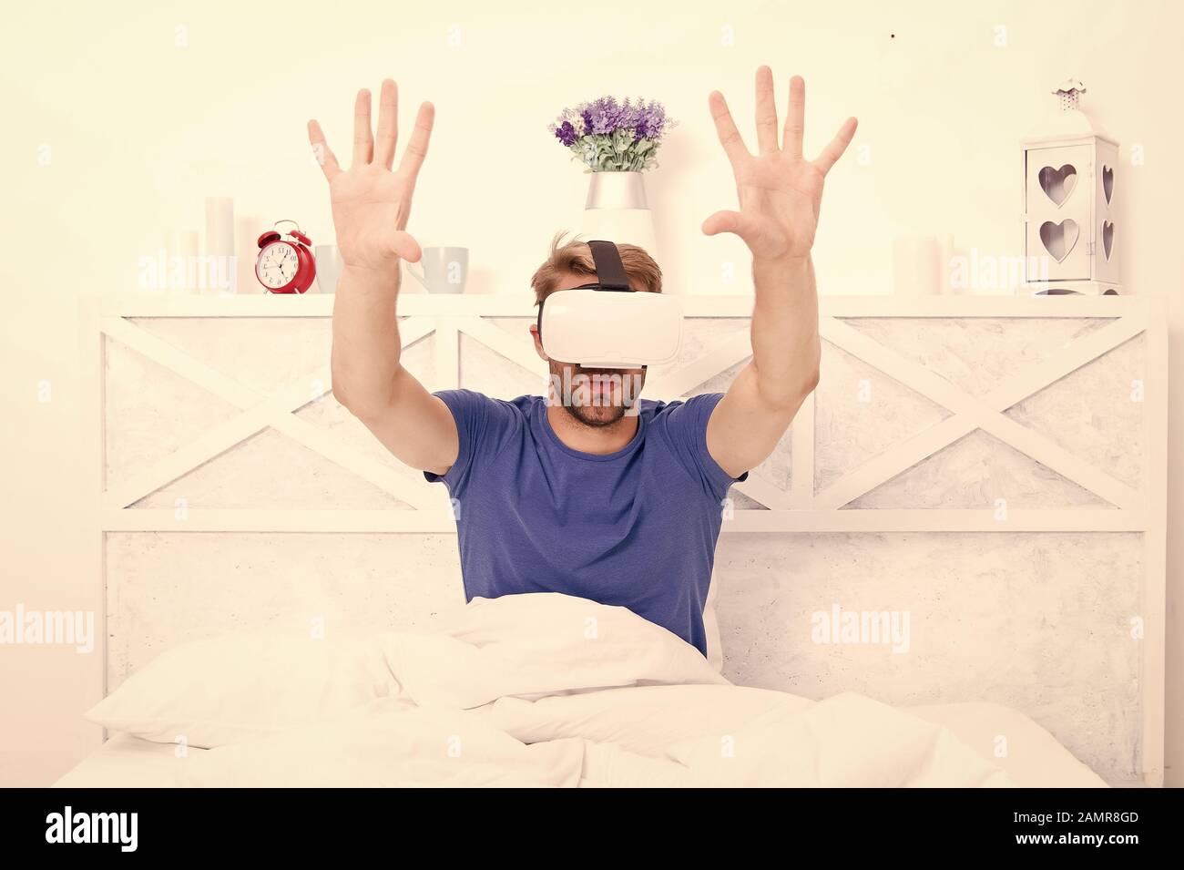 The best VR experience. Handsome guy wearing VR headset in bed ... The best VR experience. Handsome guy wearing VR headset in bed ...