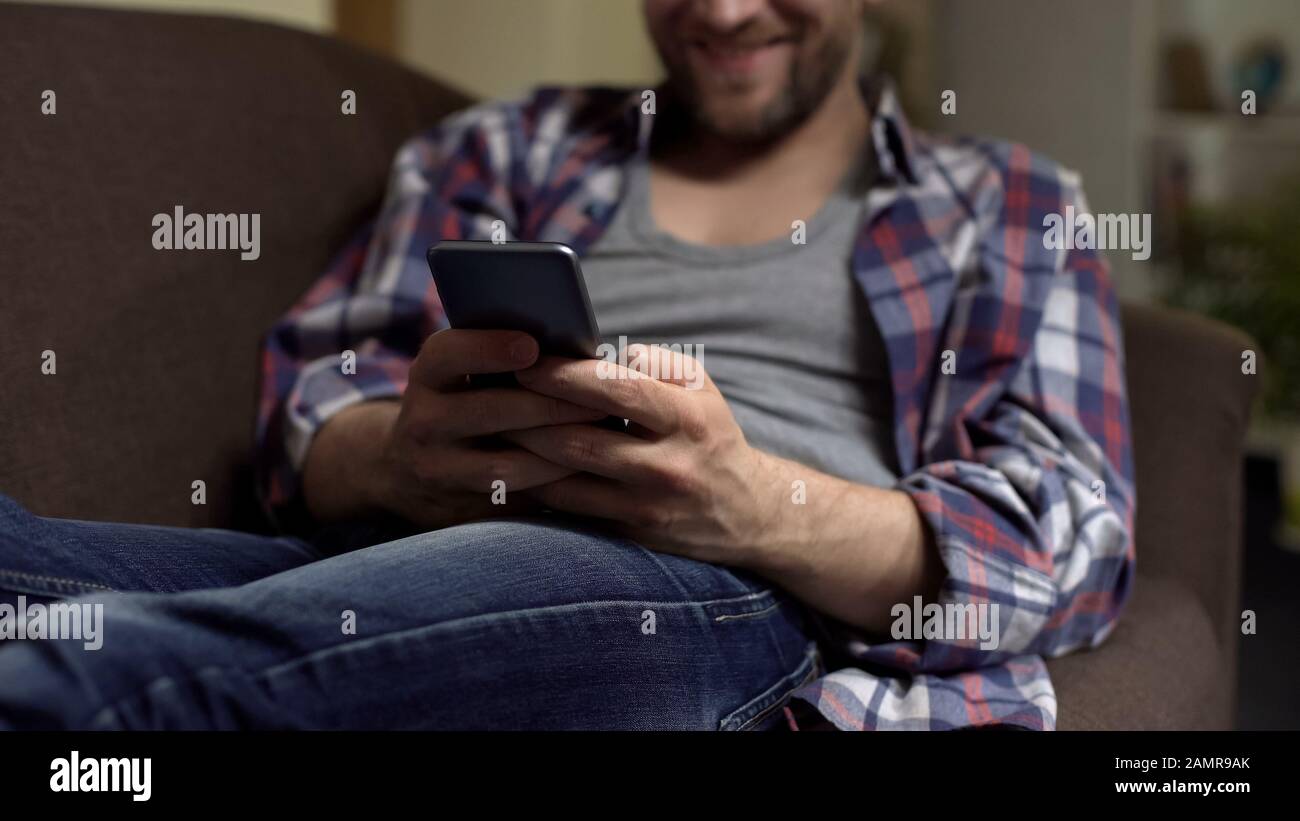 Man sitting home typing message hi-res stock photography and images - Alamy