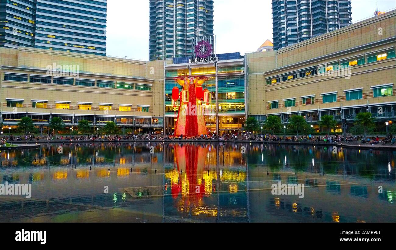Multi-colored dancing fountains near the twin towers of Petronas in ...