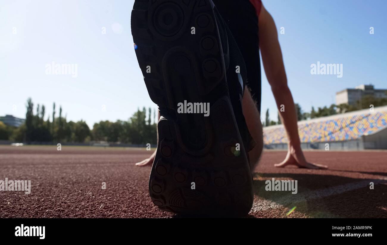 Man at running track in starting position hi-res stock photography and ...