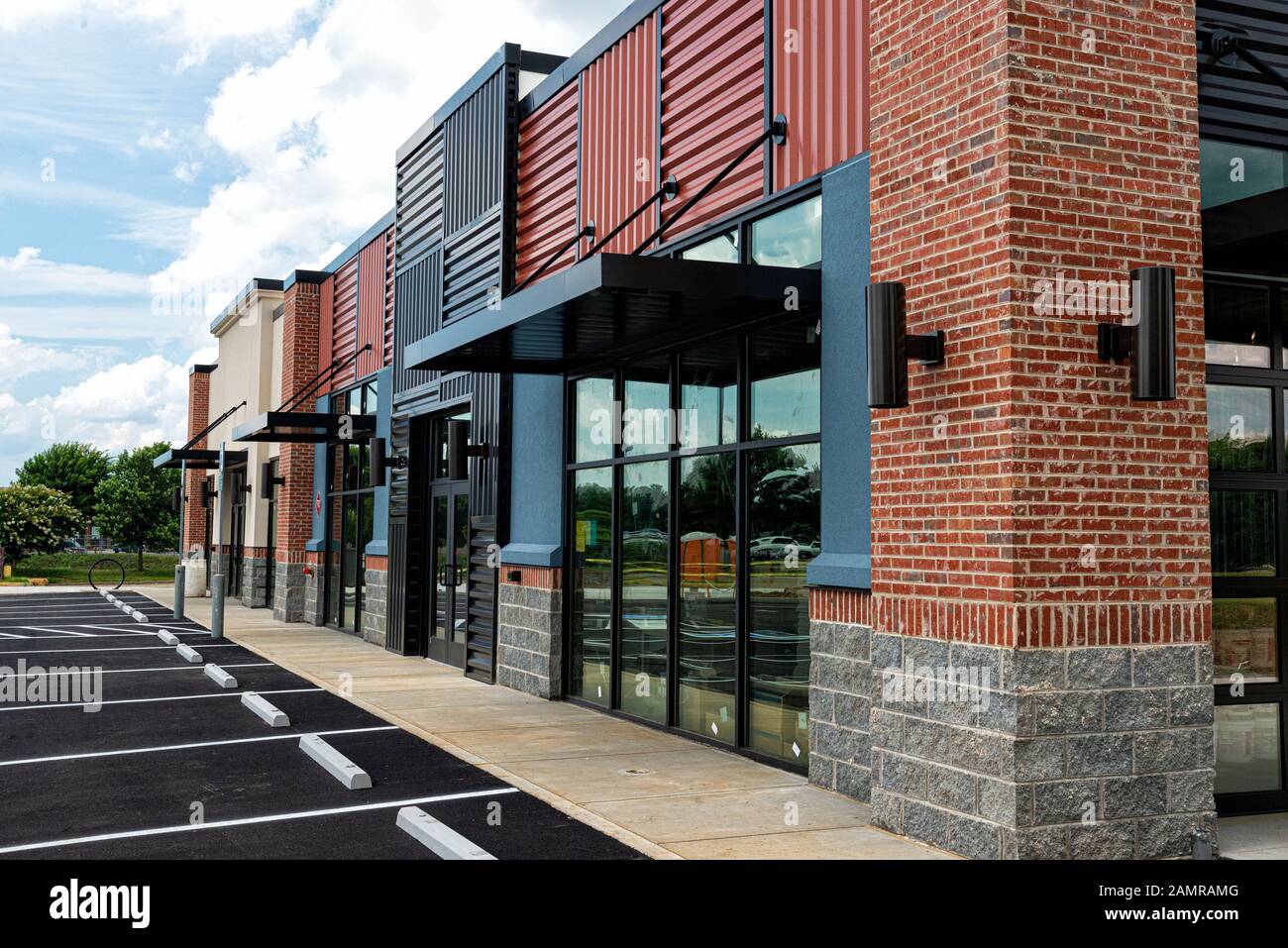 Horizontal shot of a new strip shopping center almost ready to open ...