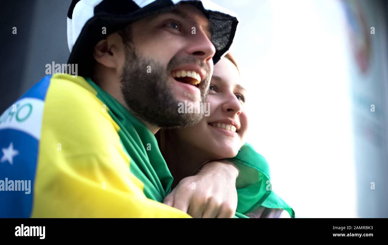 Excited Brazil football fans hugging and celebrating victory of ...