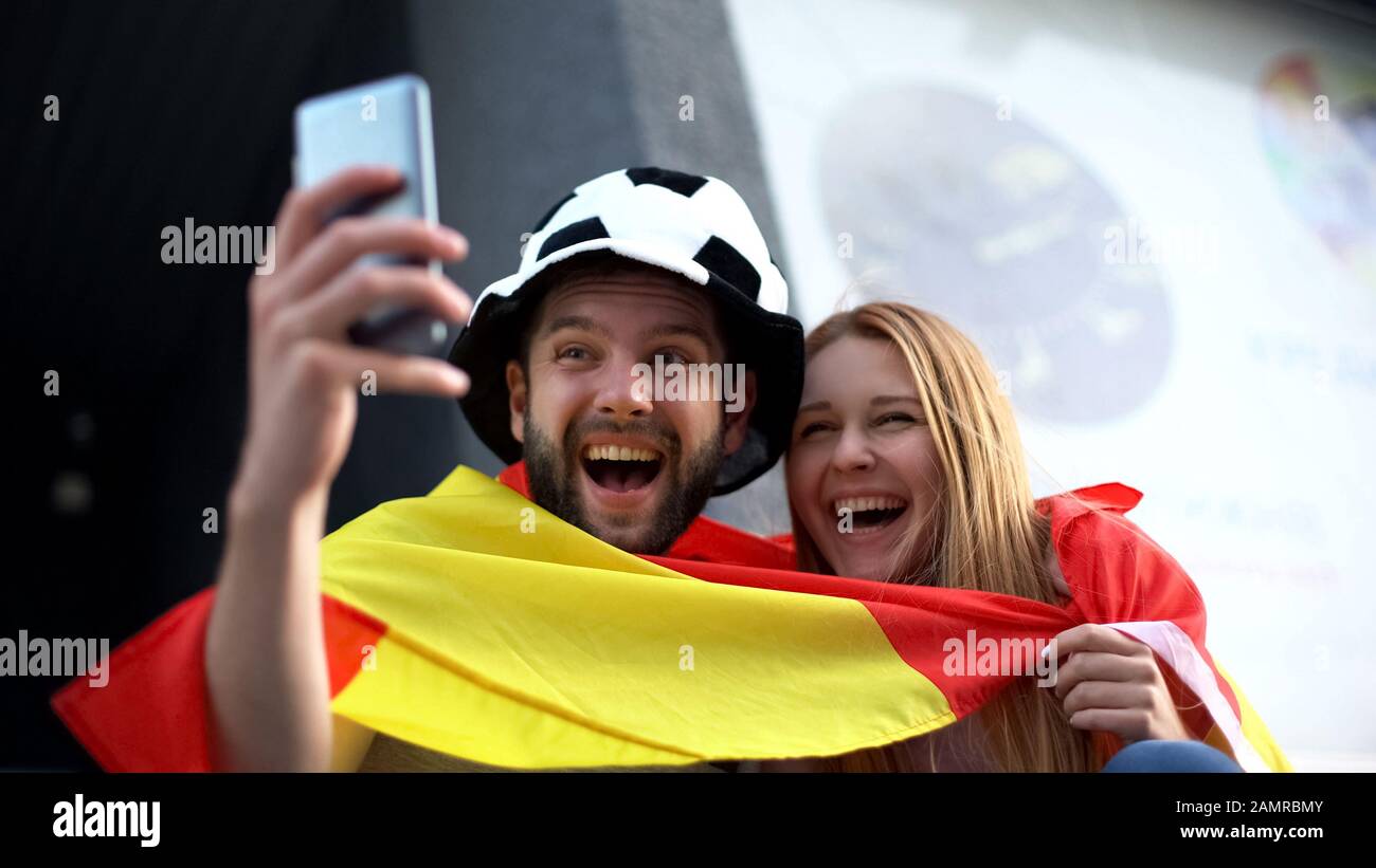 Football supporters calling via video app to friends from stadium ...
