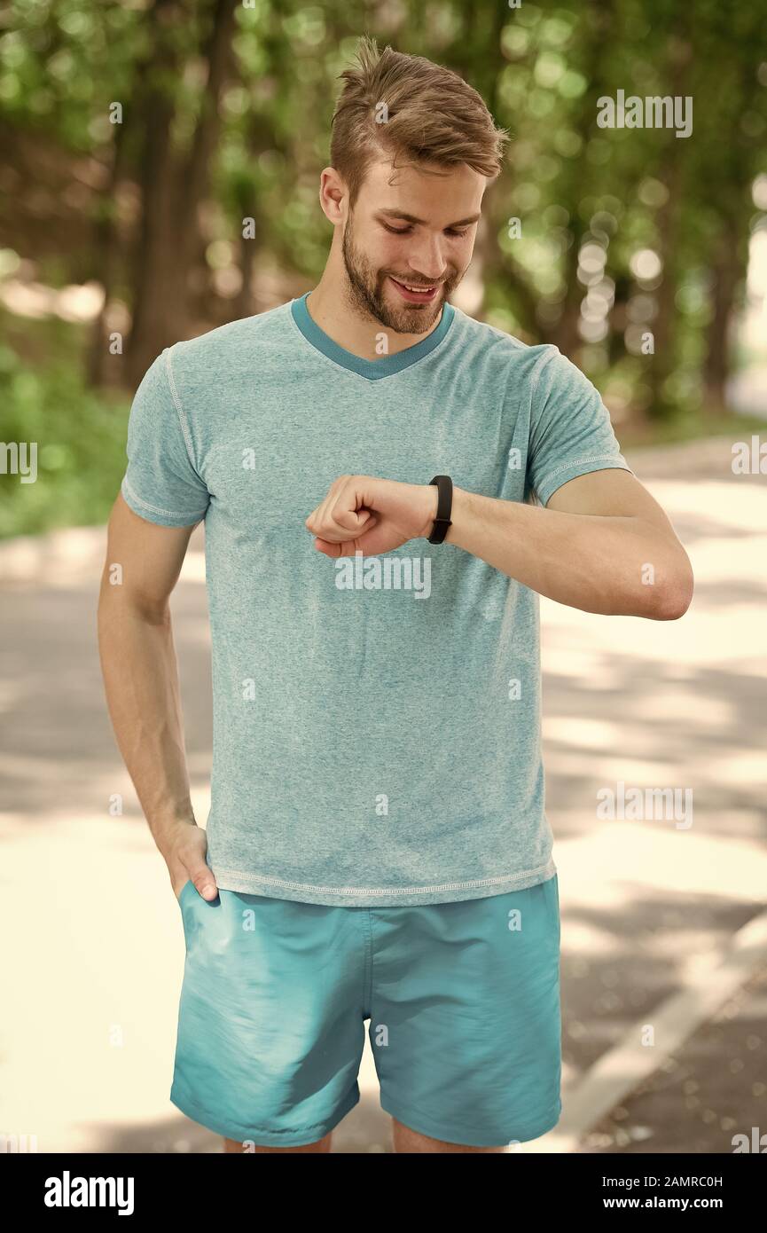 Best for training. Sportsman tracking his training with a sports watch ...
