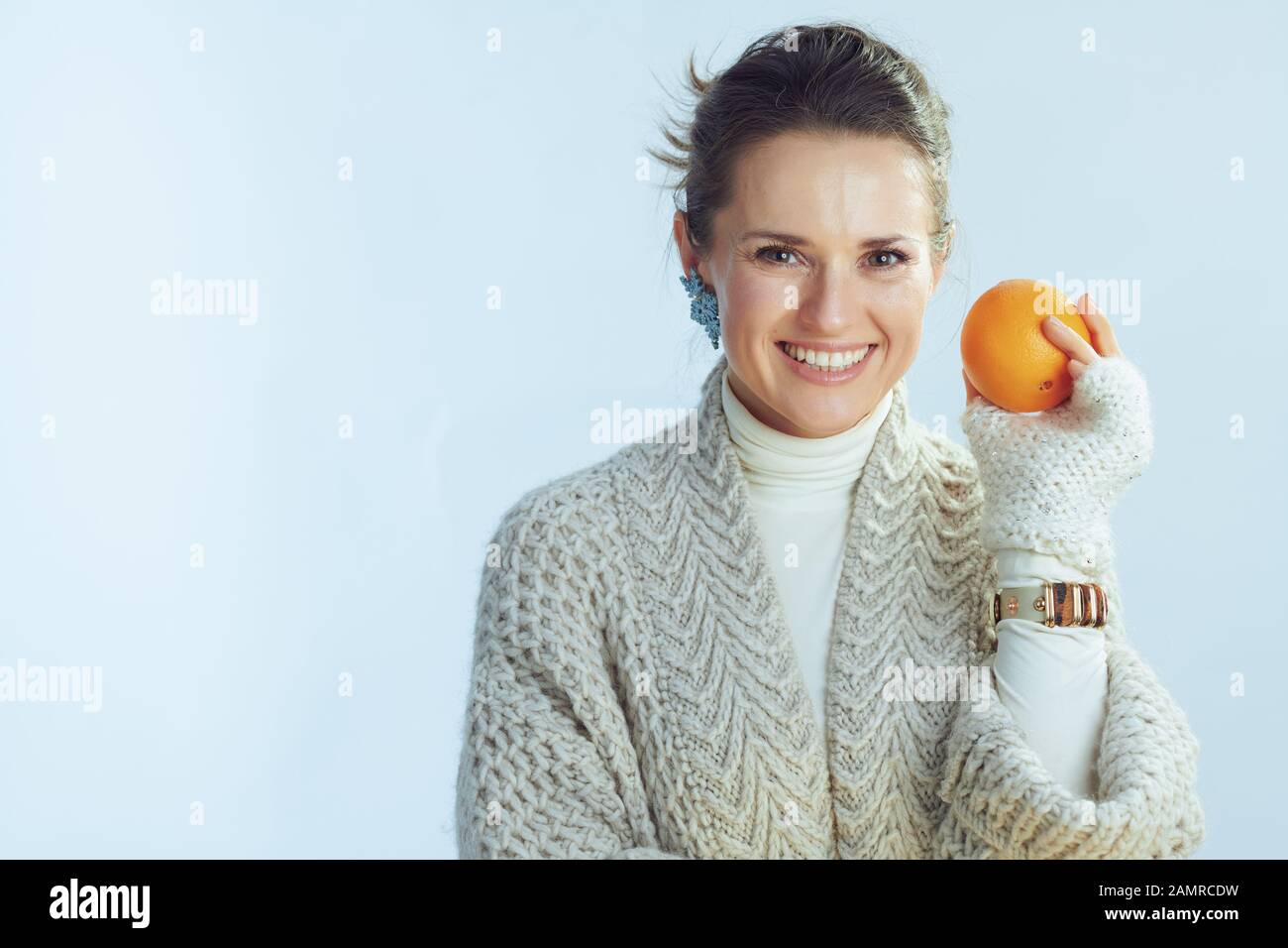 Portrait Of Smiling Elegant Woman In Roll Neck Sweater And Cardigan