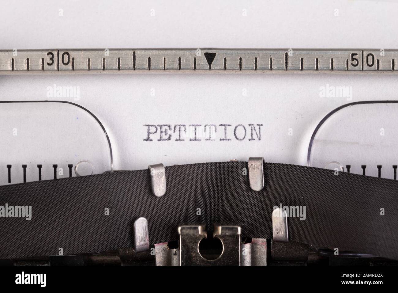 The inscription "petition" on a white sheet of paper in an old ...