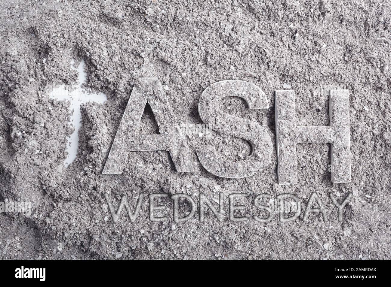 Ash wednesday word written in ash and christian cross symbol as a ...