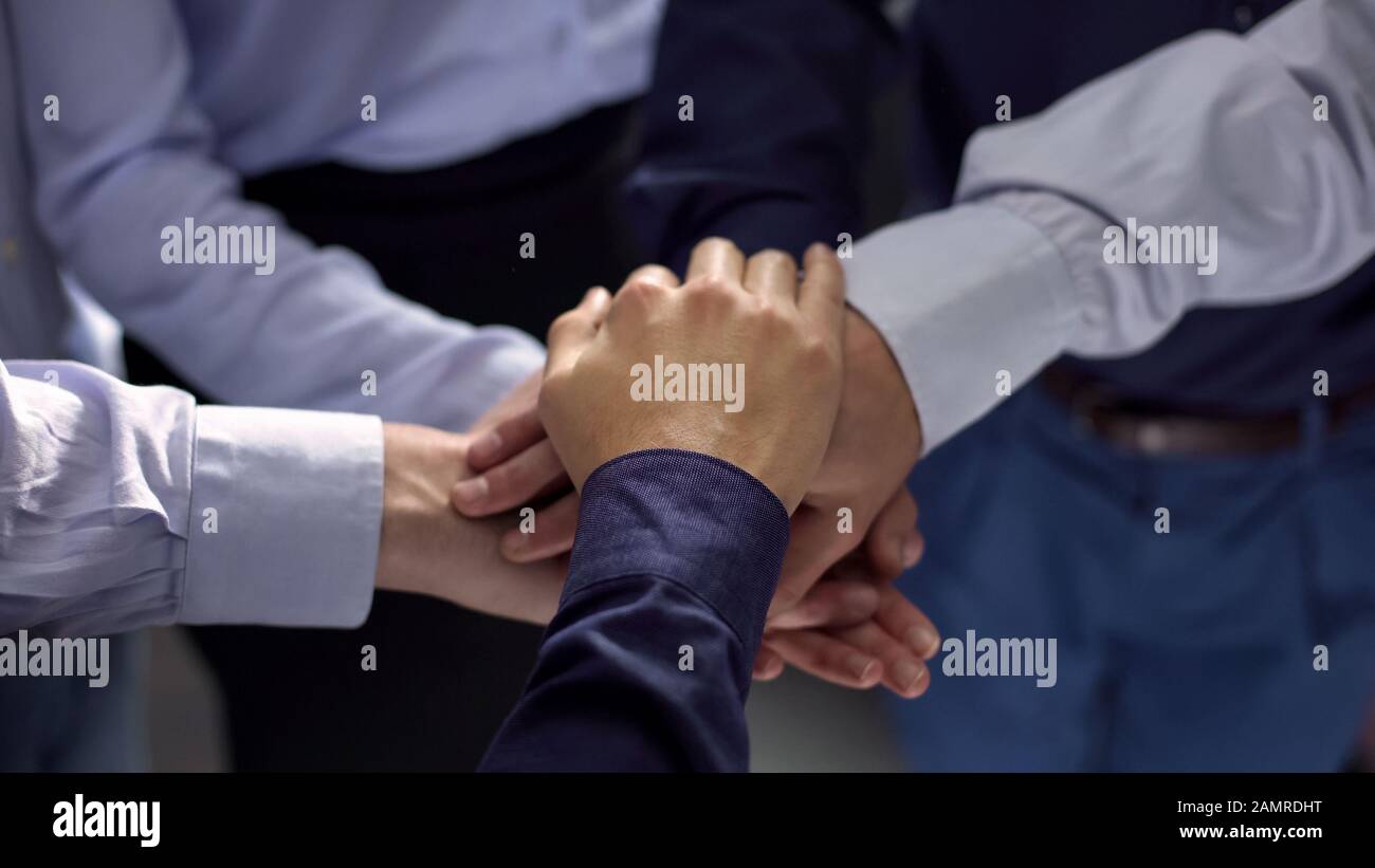 Group of business people stacking hands, team building training ...