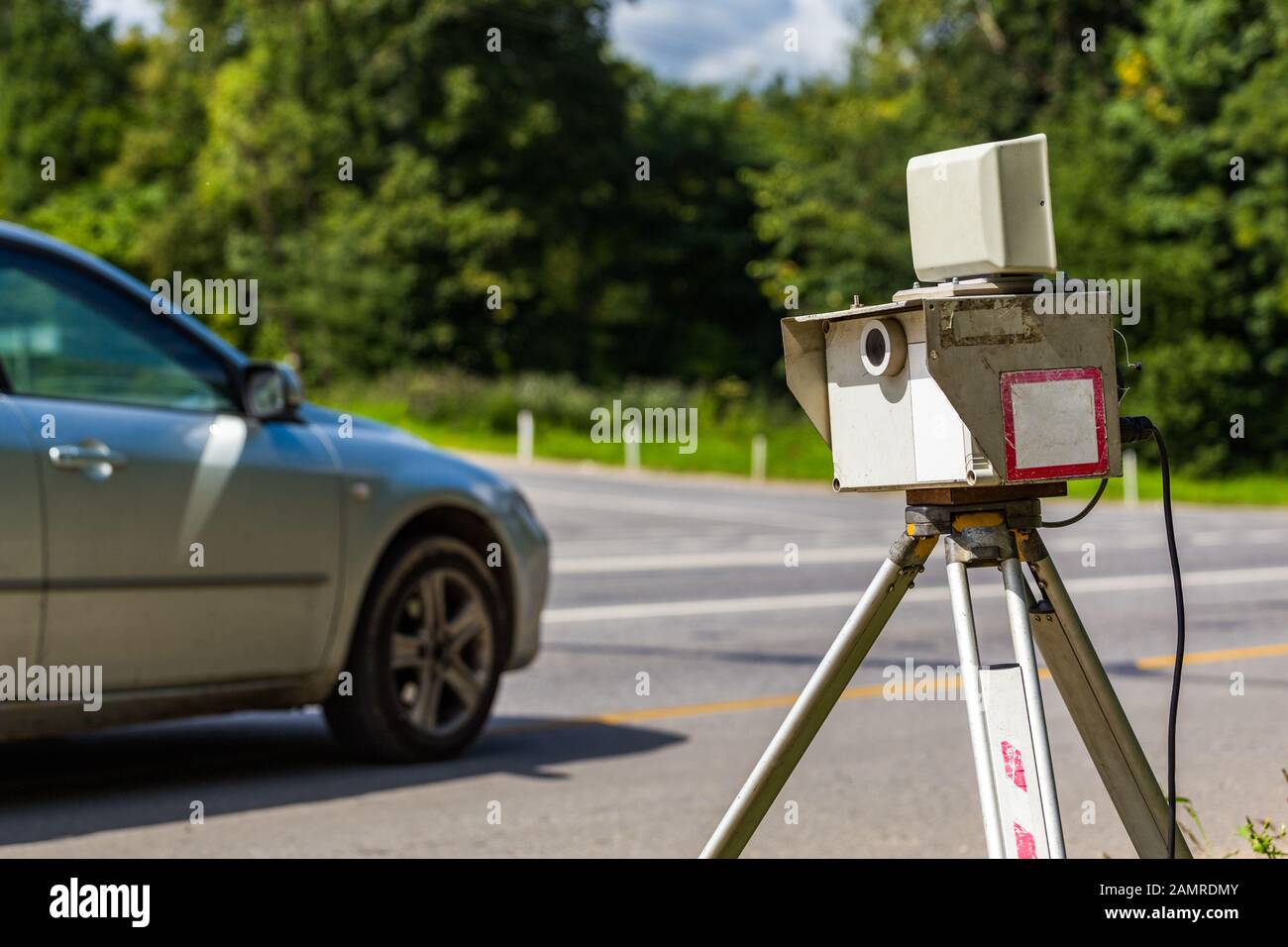 mobile speed camera device working on summer daytime road with blurry ...