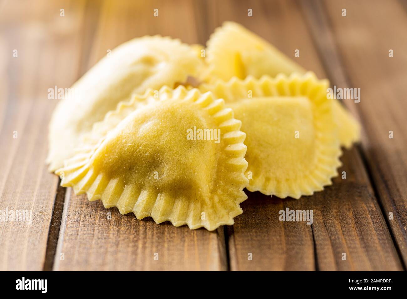 Italian stuffed pasta. Panzerotti pasta on wooden table Stock Photo - Alamy