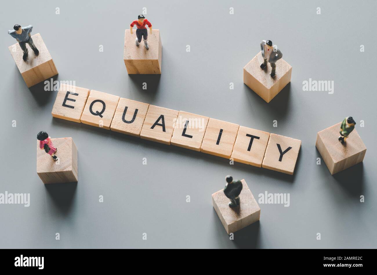 gender equality, miniature men and women stand around "equality" word ...