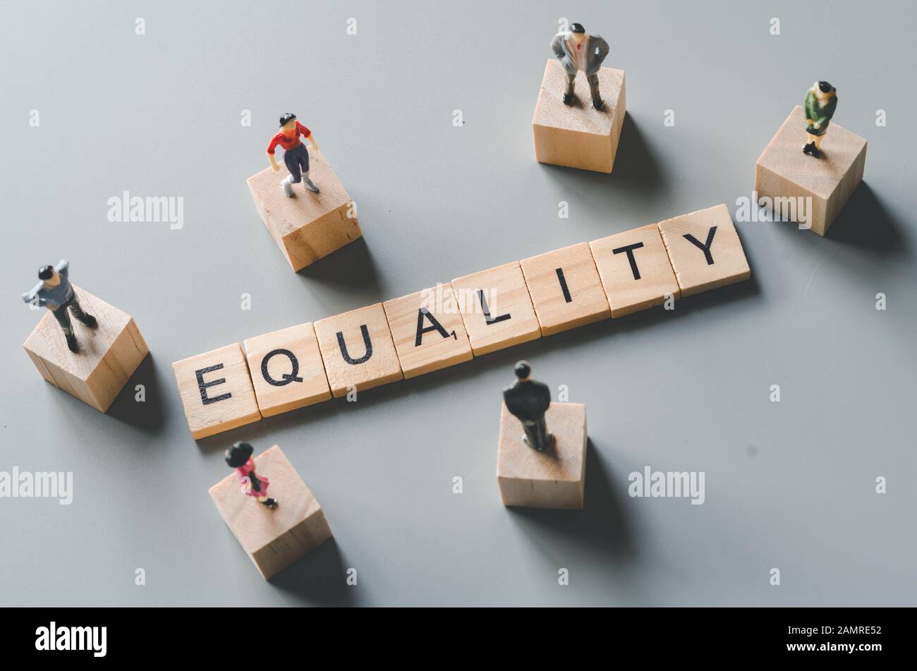 gender equality, miniature men and women stand around "equality" word ...