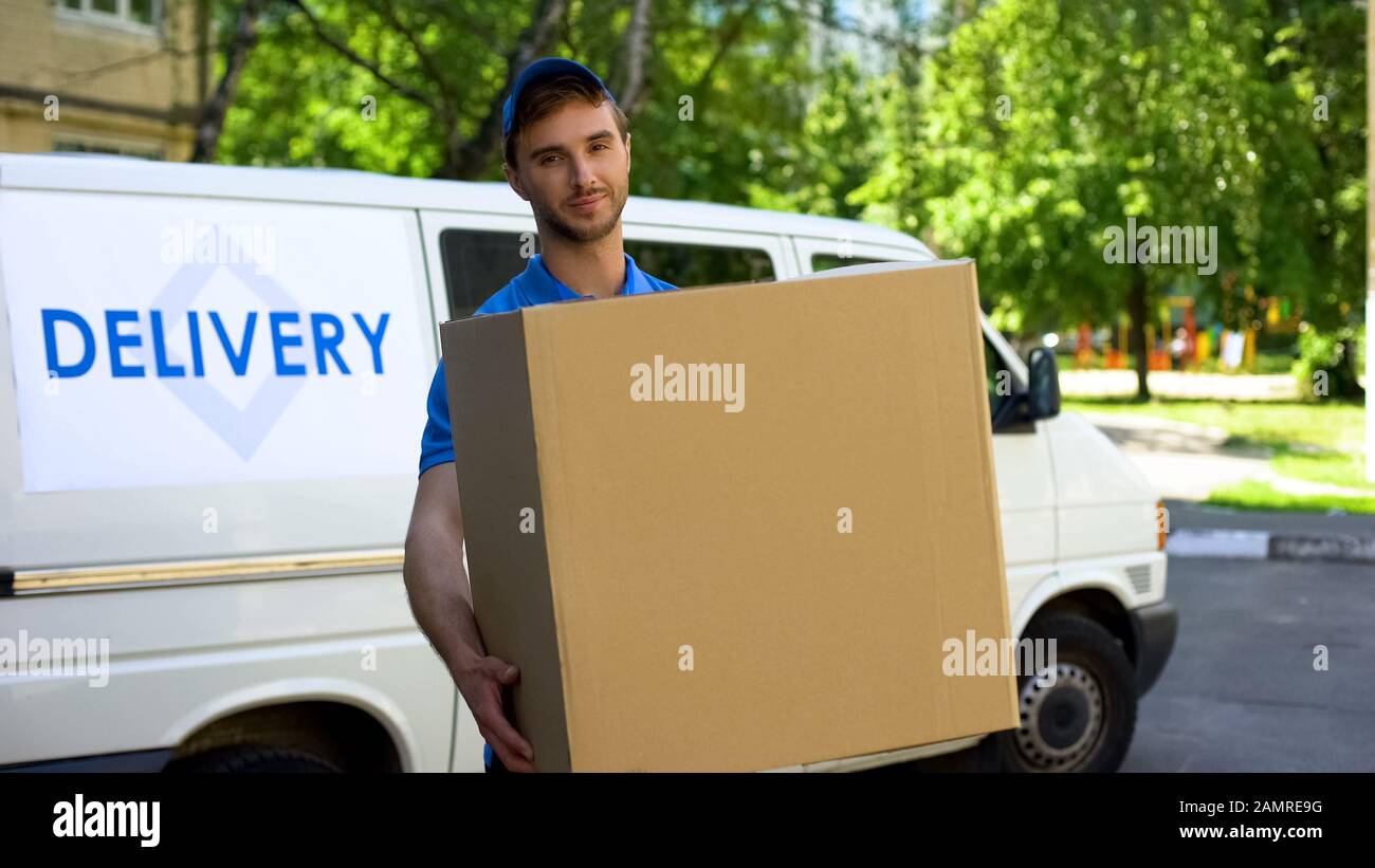 Delivery person carrying packages hi-res stock photography and images ...