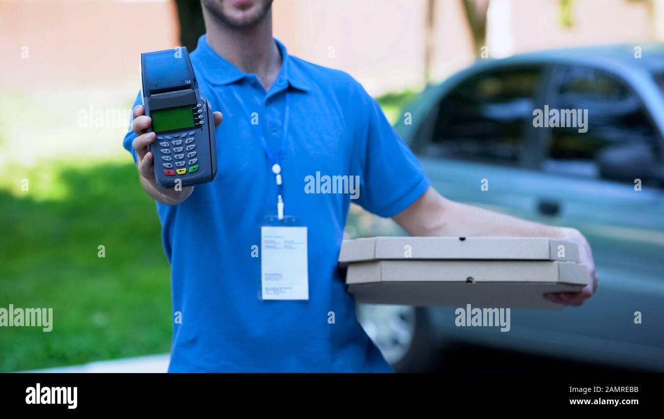 Delivery man giving payment terminal hi-res stock photography and ...
