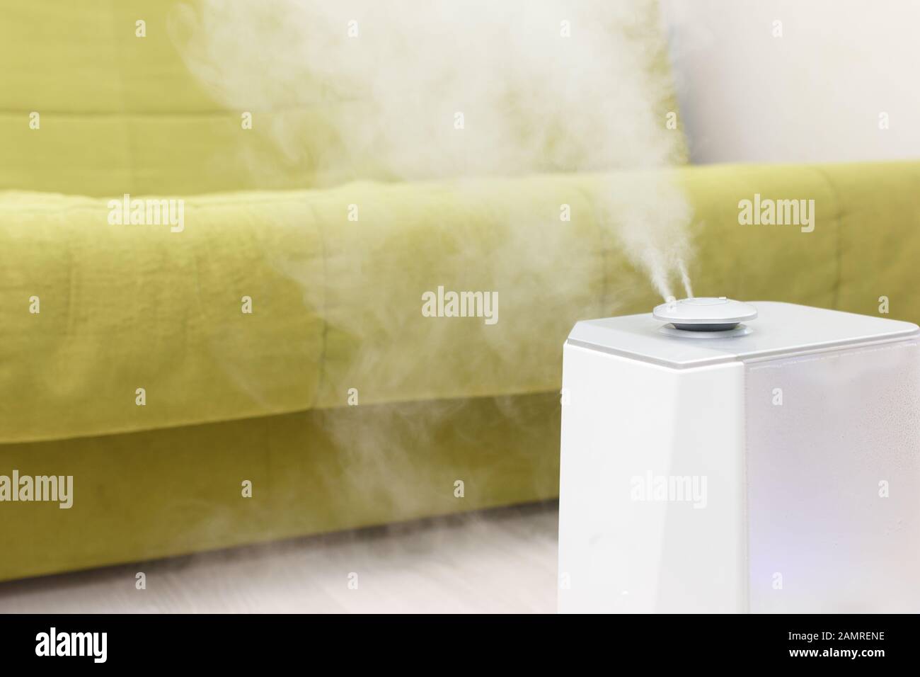 humidifier works in the room around with green sofa. Climatic systems ...