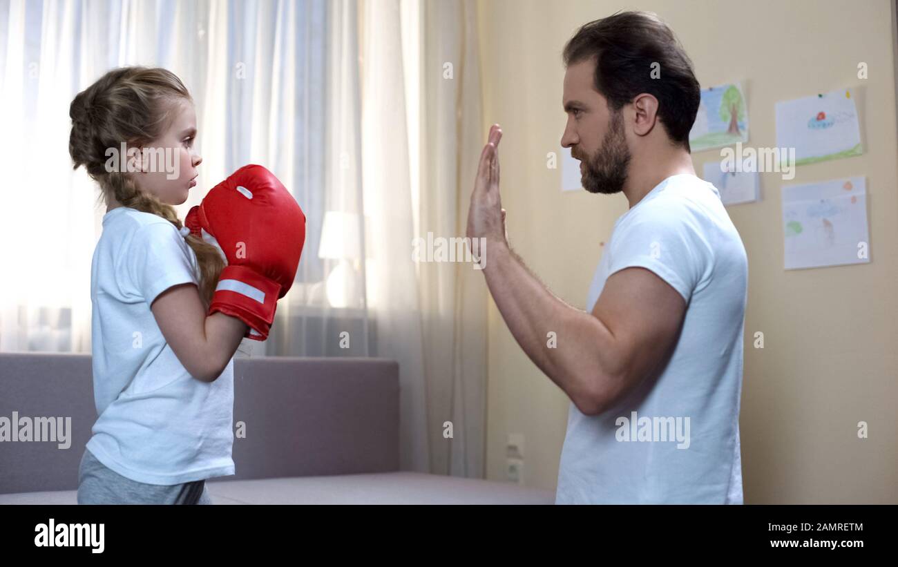 Athletic father teaching daughter boxing, sport childhood and training ...
