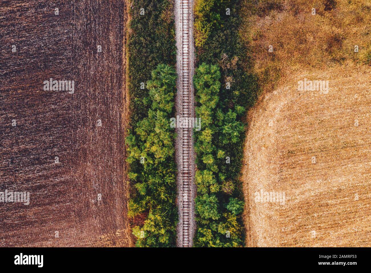 Old railroad track through countryside in autumn, aerial view from ...