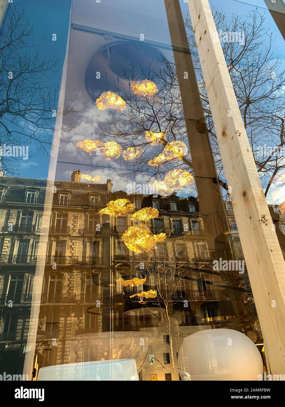 reflection in the large glass window of hausmannian houses with ...