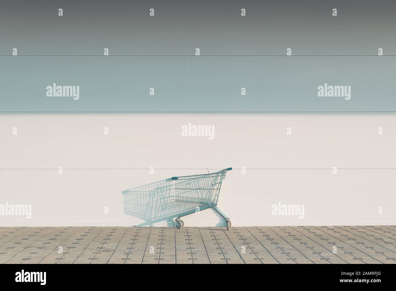 Empty shopping cart outside of the mall with blank wall as copy space ...