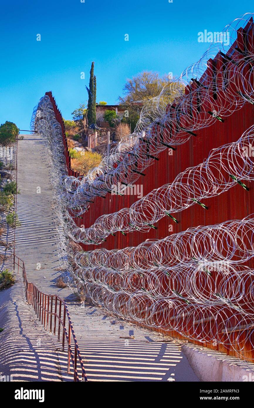 The US-Mexican border wall with layers of razor wire at Nogales AZ ...