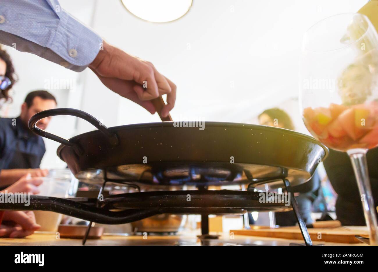 Woman and man teach her friends how to cook food, piza or pie. People ...