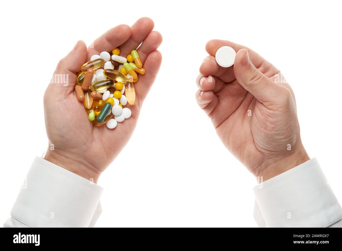 Man hand getting one pill from handful of pills, tablets, vitamins ...