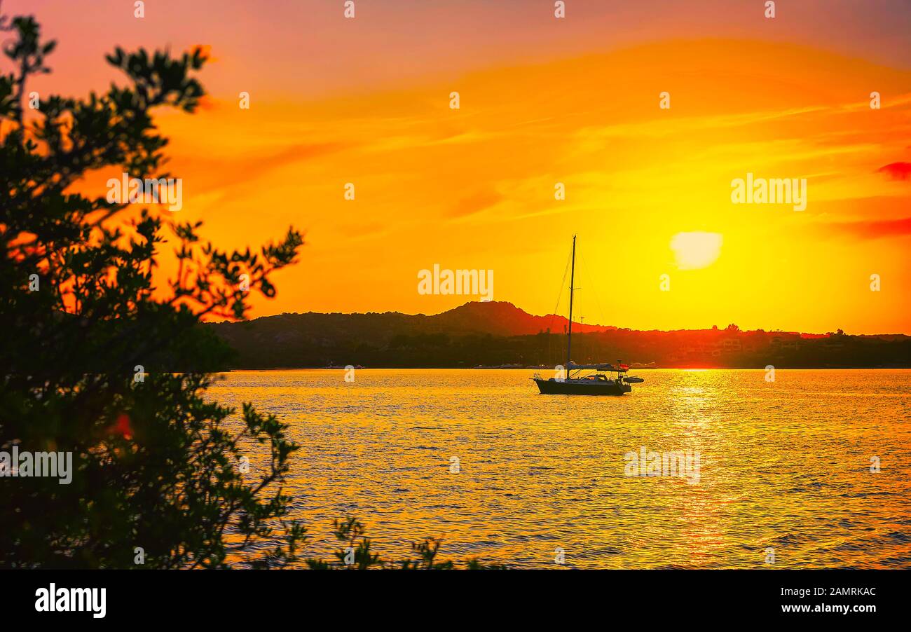 Sunrise with boat on Costa Smeralda at Mediterranean sea Sardinia ...