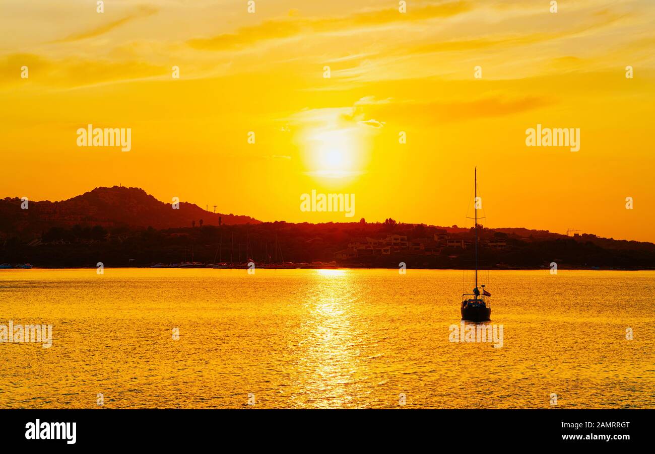Sunrise with boat in Costa Smeralda Mediterranean sea Sardinia reflex ...