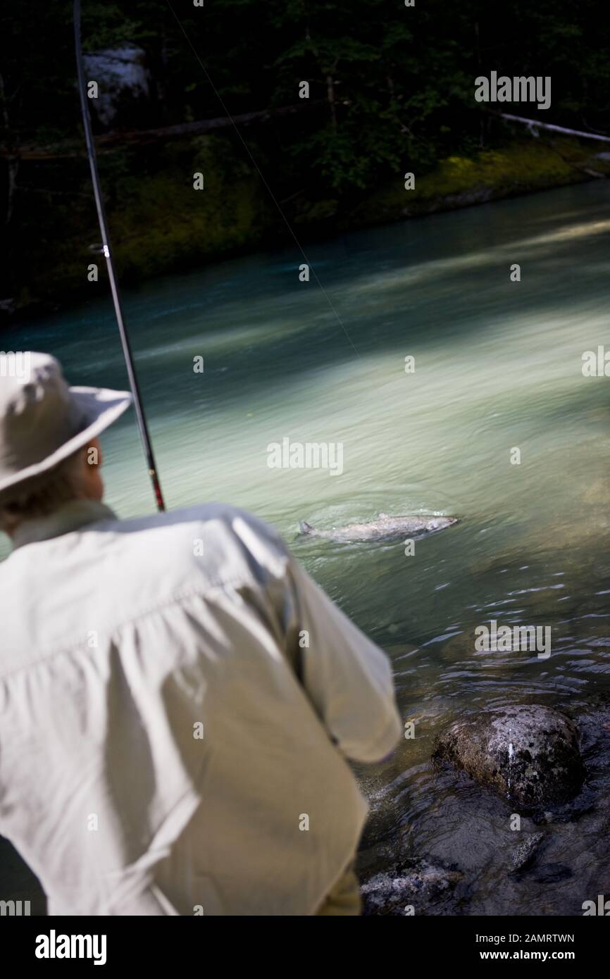Fisherman catching a large fish Stock Photo - Alamy