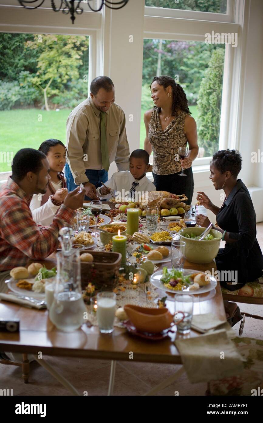Family gathered at dining table hi-res stock photography and images - Alamy