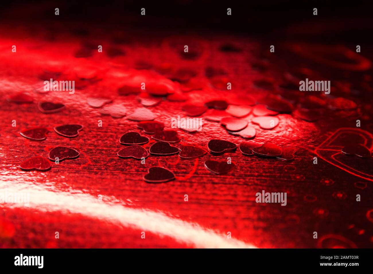 Heart shape glitter in red colors on a holographic background can be ...