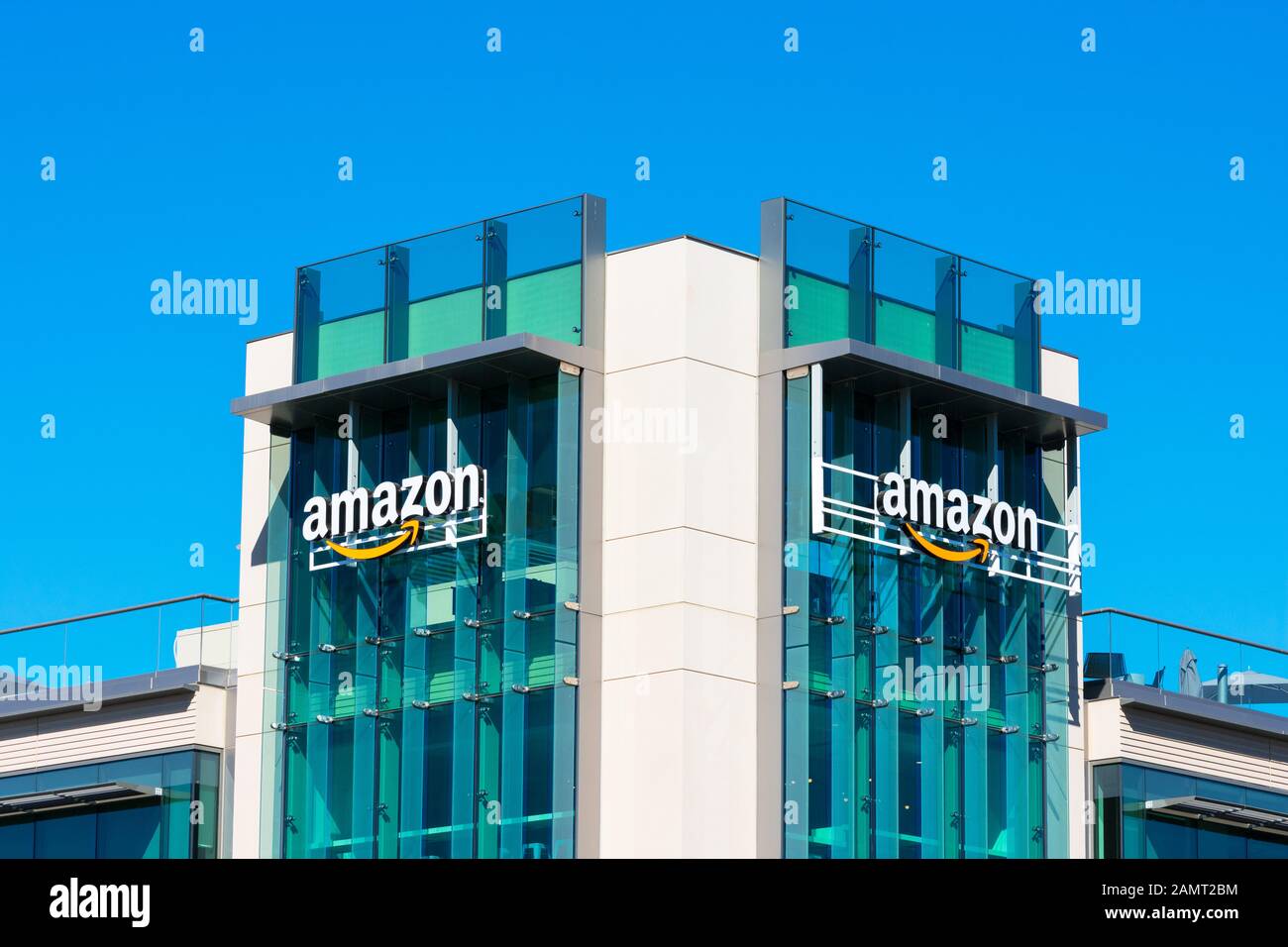 Amazon logo with its signature orange smile on the glass facade of ...