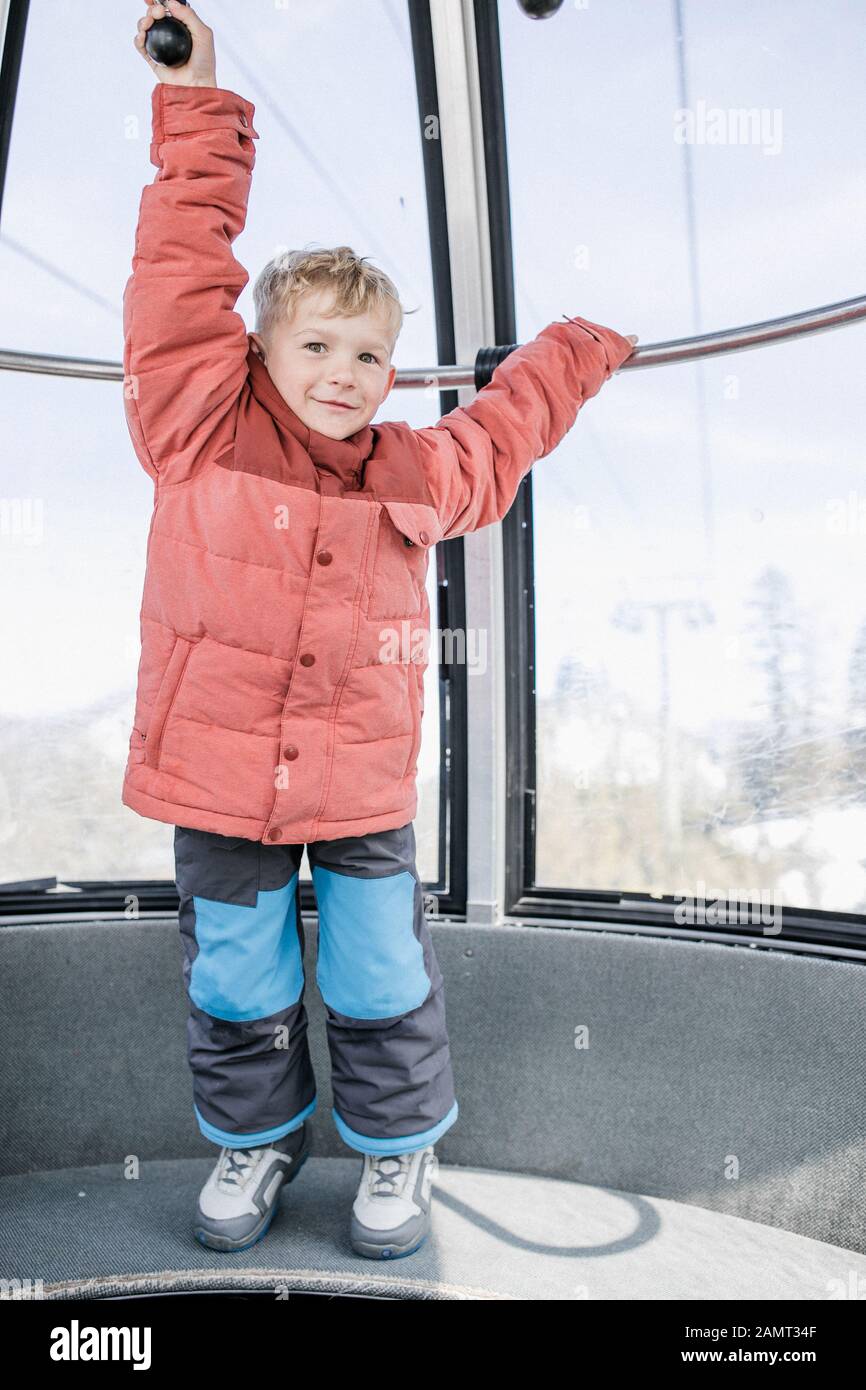 Boy standing in an overhead cable car holding onto a railing, Mammoth ...