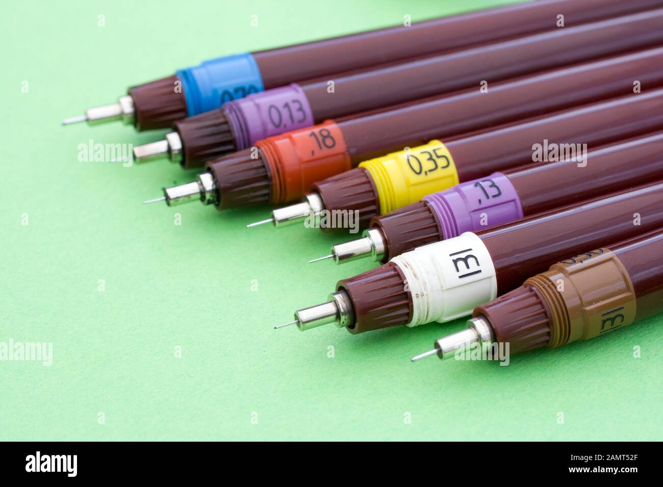 Technical drawing pens on green background Stock Photo - Alamy