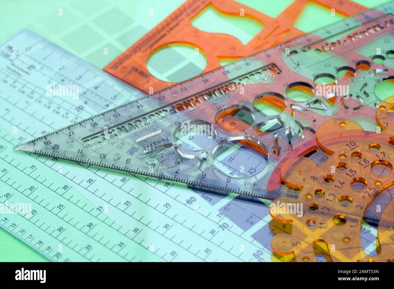 Rulers and tools on green background Stock Photo - Alamy