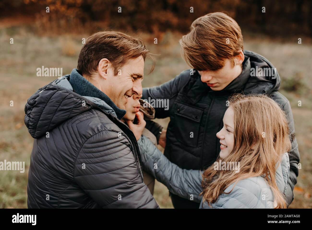 Father and three children standing in rural landscape, Netherlands ...
