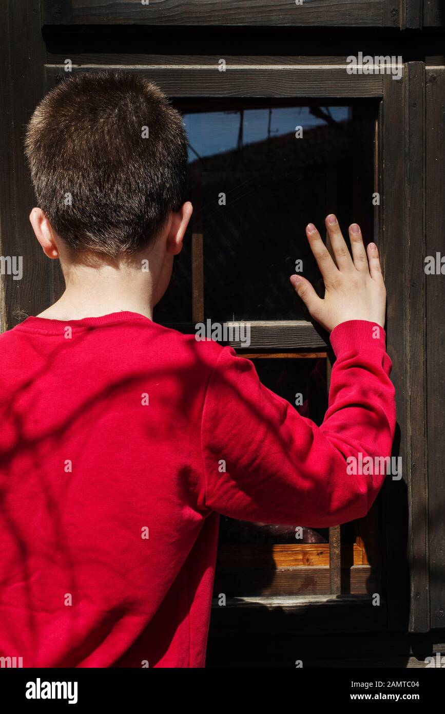 Boy looking through a window, Bulgaria Stock Photo - Alamy