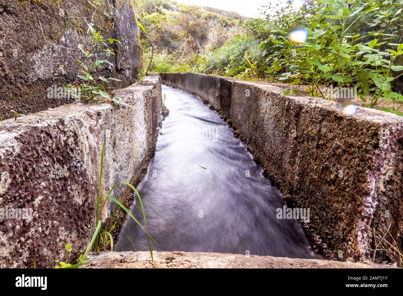 stone water channel full of running water in Tierra del Trigo village ...