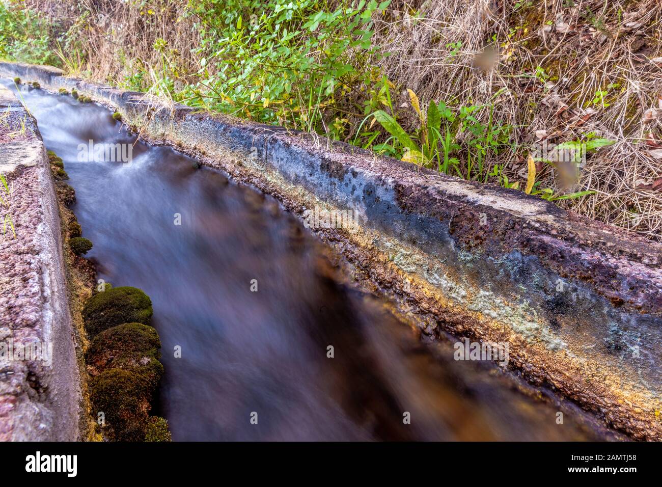 stone water channel full of running water in Tierra del Trigo village ...