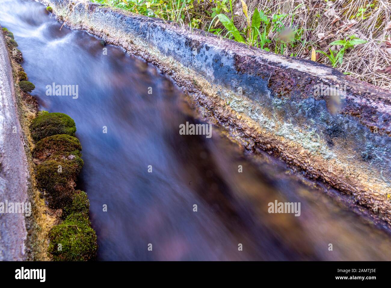 stone water channel full of running water in Tierra del Trigo village ...