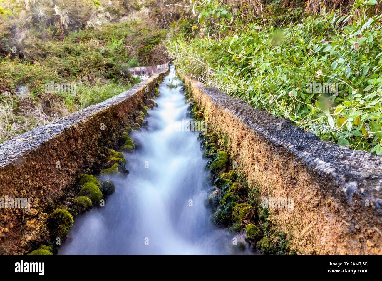 stone water channel full of running water in Tierra del Trigo village ...